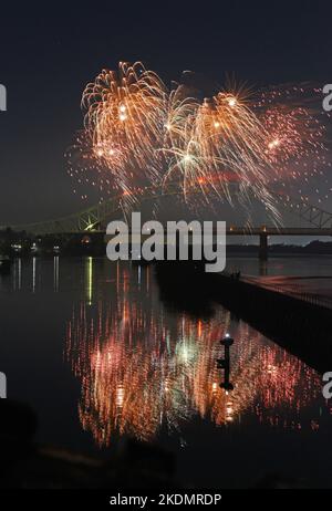 Relections in the Manchester Ship Canal of the exploding fireworks ...