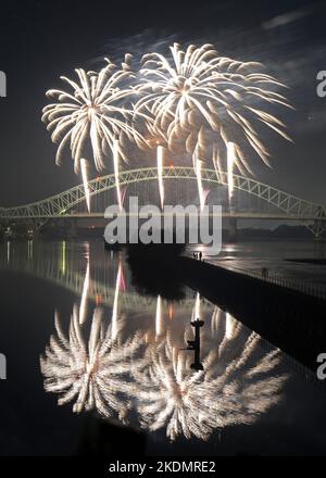 Relections in the Manchester Ship Canal of the exploding fireworks ...