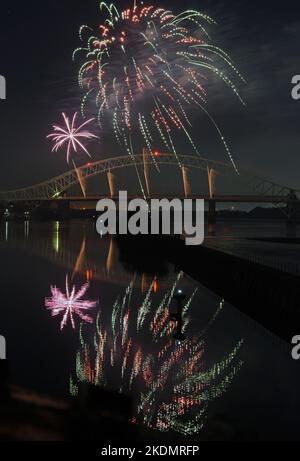 Relections in the Manchester Ship Canal of the exploding fireworks ...