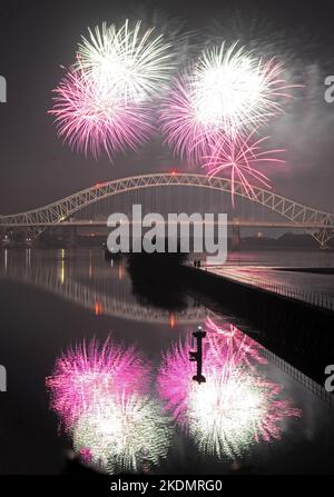 Relections in the Manchester Ship Canal of the exploding fireworks ...