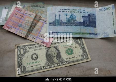US dollar, Lebanese pound and Iranian rial banknotes seen on November ...