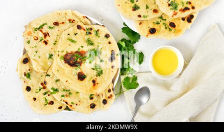 Indian naan bread over light background with copy space. Top view, flat ...