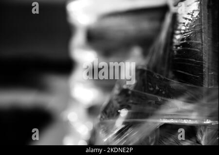 Selective focus on cellophane shrink wrap on pallets of goods for ...