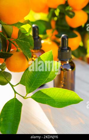 Bottles of essential oils, green leaves and text NATURAL COSMETICS on ...