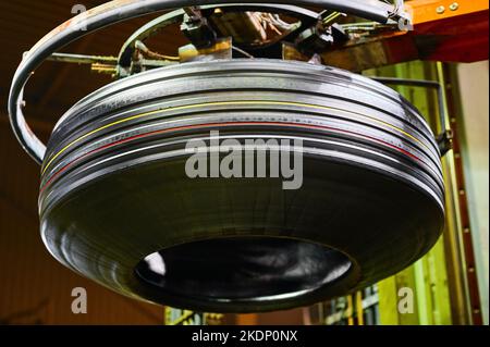 Automatic manipulators carry raw tire to vulcanization press Stock ...