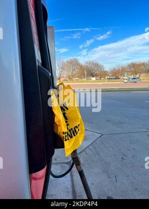 Bag with wording posting - Out of Service - over a gas station service ...