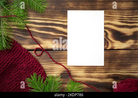 Started knitting on knitting needles, with yarn on a rustic wooden ...