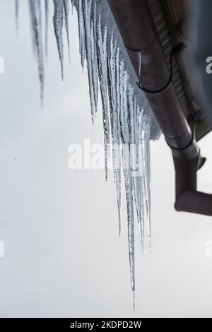 icicles hanging from the roof Stock Photo - Alamy