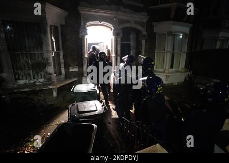 Officers from Metropolitan Police raid a house in Islington, north ...