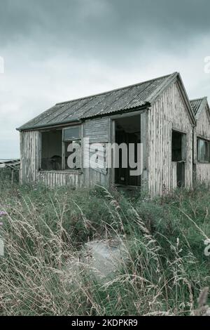 Old abandoned huts with an eerie spooky atmosphere Stock Photo - Alamy