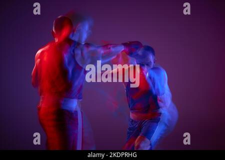 Unfocused effect portrait of two professional boxers boxing isolated on ...