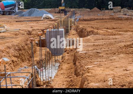 Trench at construction site with reinforced concrete footings for ...