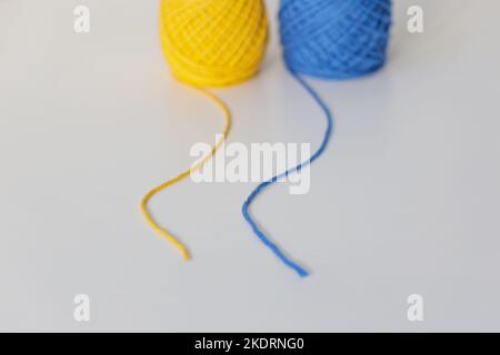 Yellow and blue threads on a gray background with a place for writing ...