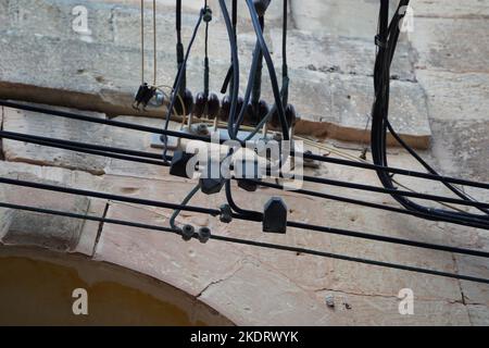 Malta electric wires hanging on building detail Stock Photo - Alamy