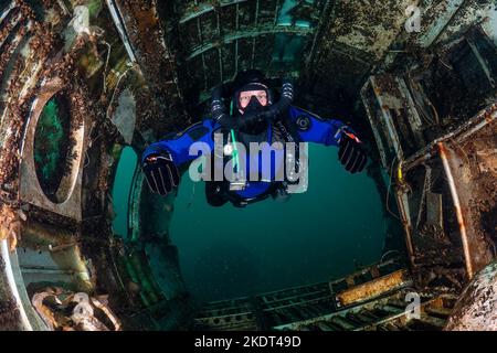 Scuba diver on a closed circuit rebreather and underwater camera ...