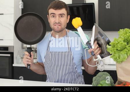 Multitasking man at home, ironing laundry and using smartphone Stock ...