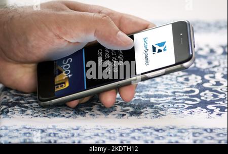 human hand scrolling Boston Dynamics website on a phone screen Stock ...