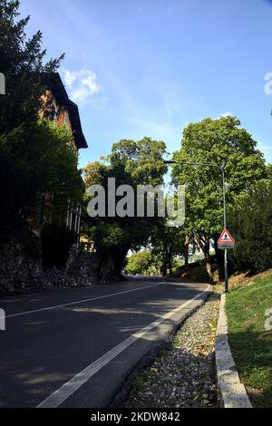 Uphill road next to a building in an italian town Stock Photo - Alamy