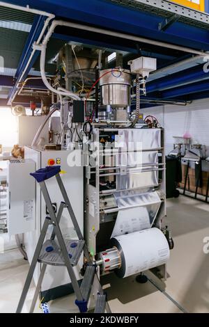 Coffee packaging, bagging and stacking machine Stock Photo - Alamy
