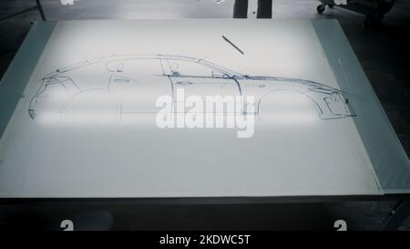 Senior automotive male designer drawing sketch blueprint with marker at ...