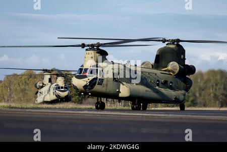 Two CH-47F Chinook helicopters take off. Boeing CH-47 Chinooks ...