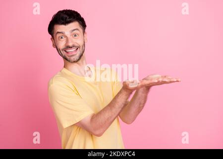 Photo of surprised optimistic brunet hair guy smile hold fists wear ...