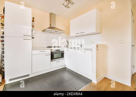 Table with chairs and flowers located near lounge area and kitchen in ...