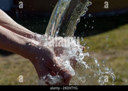Splahing water on human hands Stock Photo - Alamy