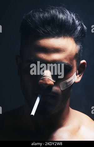 Boxer, man and cigarette smoking after fight, blood and bandage from ...