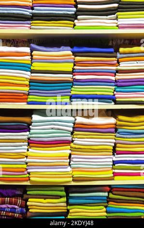 Colorful folded fabric and textile materials displayed in home ...