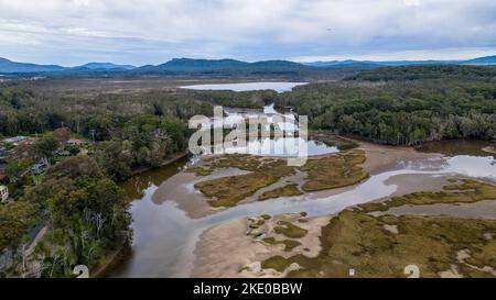 An aerial shot of the Lake Cathie surrounded by lush trees in New South ...