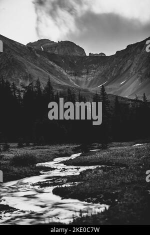 A grayscale shot of the silhouettes of mountains Stock Photo - Alamy