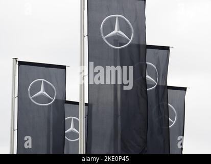 Flags with the Mercedes-Benz logo are seen in front of the Mercedes ...