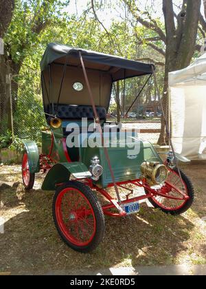 Antique green 1902 Rambler Model D Runabout roadster in a park. Nature ...
