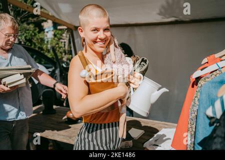 happy germany female customer looking for lipstick in cosmetics shop ...