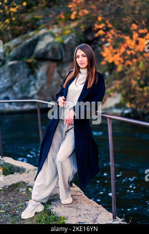A beautiful Ukrainian woman in a black embroidered dress on a dark ...