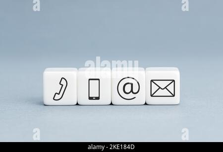 Contact us icons on white cube blocks. Copy space Stock Photo - Alamy