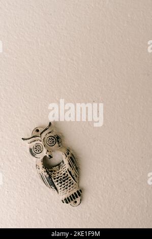 Owl mask on a white brick wall backgraound Stock Photo - Alamy
