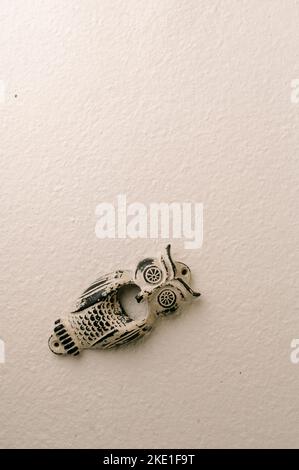 Owl mask on a white brick wall backgraound Stock Photo - Alamy