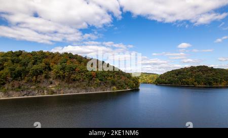 A drone shot of the New Croton Reservoir on a sunny day in autumn with ...