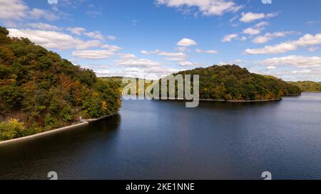 A drone shot of the New Croton Reservoir on a sunny day in autumn with ...