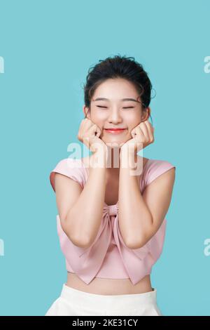 Portrait of an adorable woman with open palms near face having fun ...