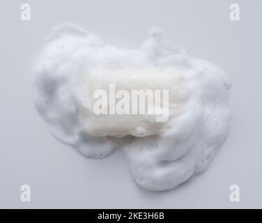 Soap with fluffy foam isolated on white Stock Photo - Alamy