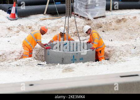 motorway construction workers installing an FP McCann precast concrete ...