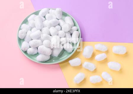 Plate of soft cotton balls on color background Stock Photo - Alamy