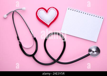 Notebook with stethoscope on a pink table Stock Photo - Alamy
