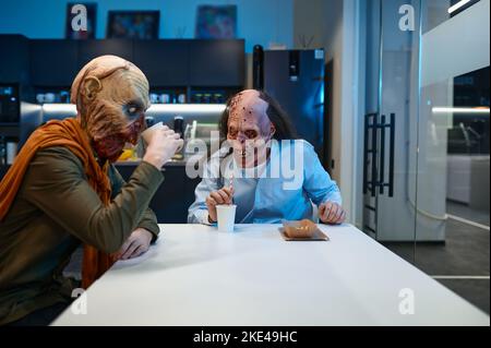 Zombie colleagues have fun eating food, drinking coffee. Lunch time ...