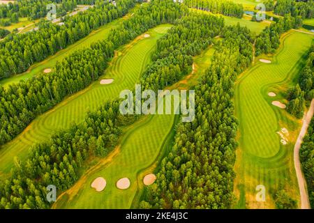 Top view of the golf course located in a wooded area Stock Photo - Alamy
