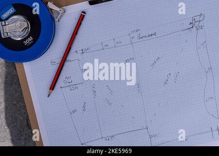 making a plan of a garden using tape measure, graph paper and a pencil ...