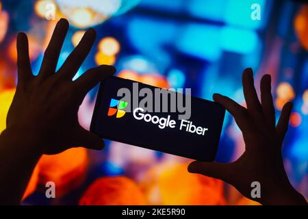 In this photo illustration, the Google Fiber logo is displayed on a ...
